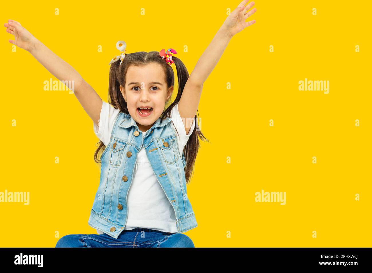 funny child girl on colored yellow background Stock Photo - Alamy
