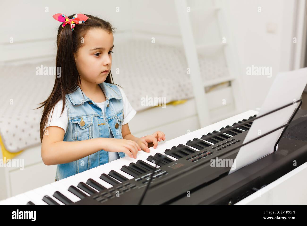 Happy Small Girl with the Piano Keyboard Stock Photo - Alamy