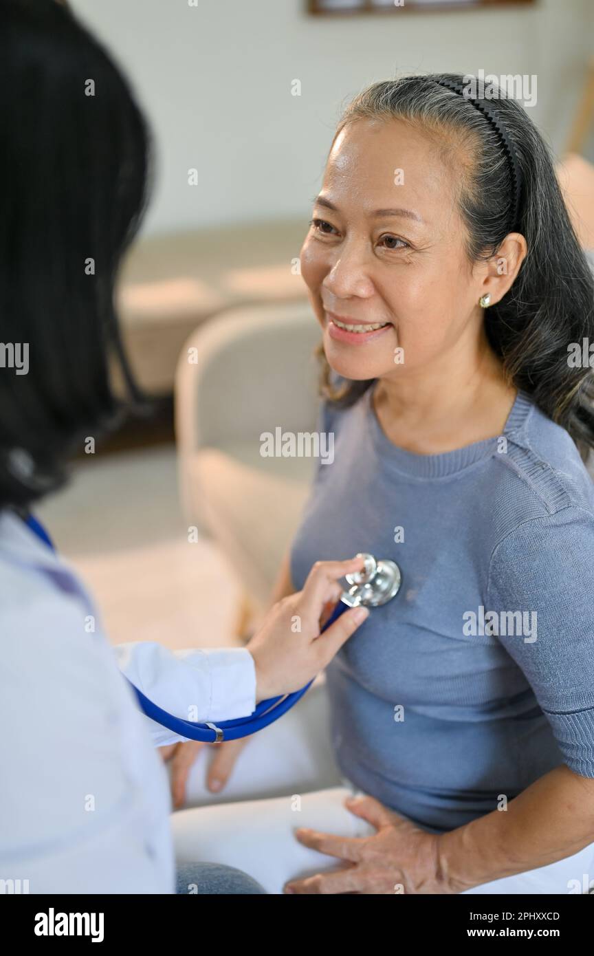 Happy and attractive senior Asian woman is having her heart and lungs ...