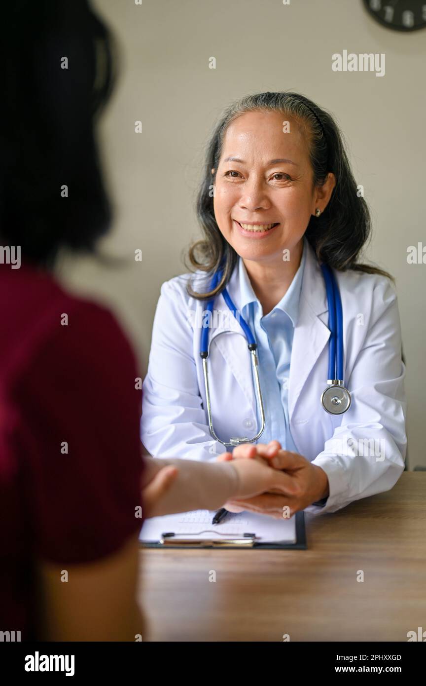 Positive an professional senior Asian female orthopedic doctor ...