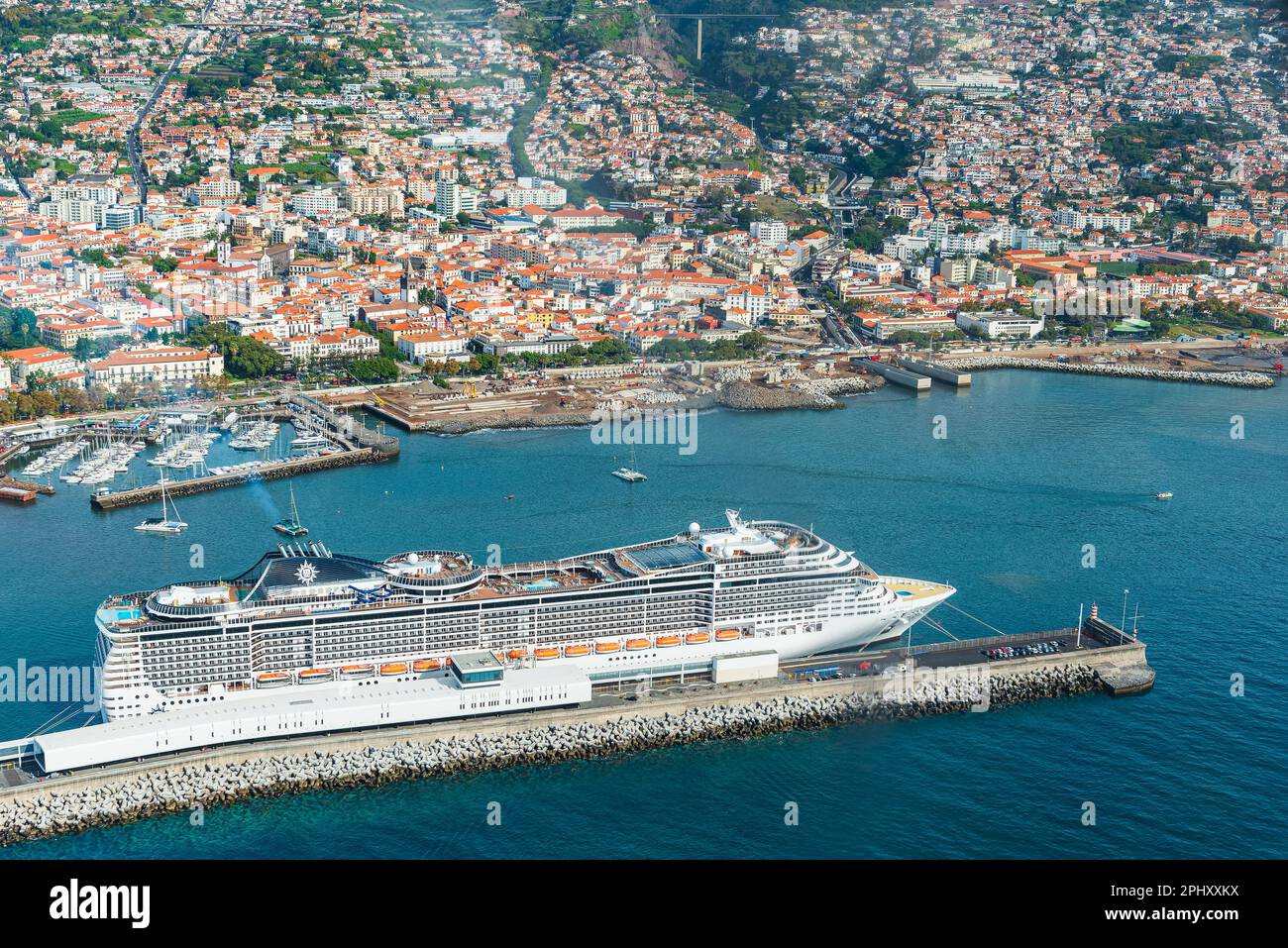 An aerial view of Funchals bustling port and harbor, with a variety of ...
