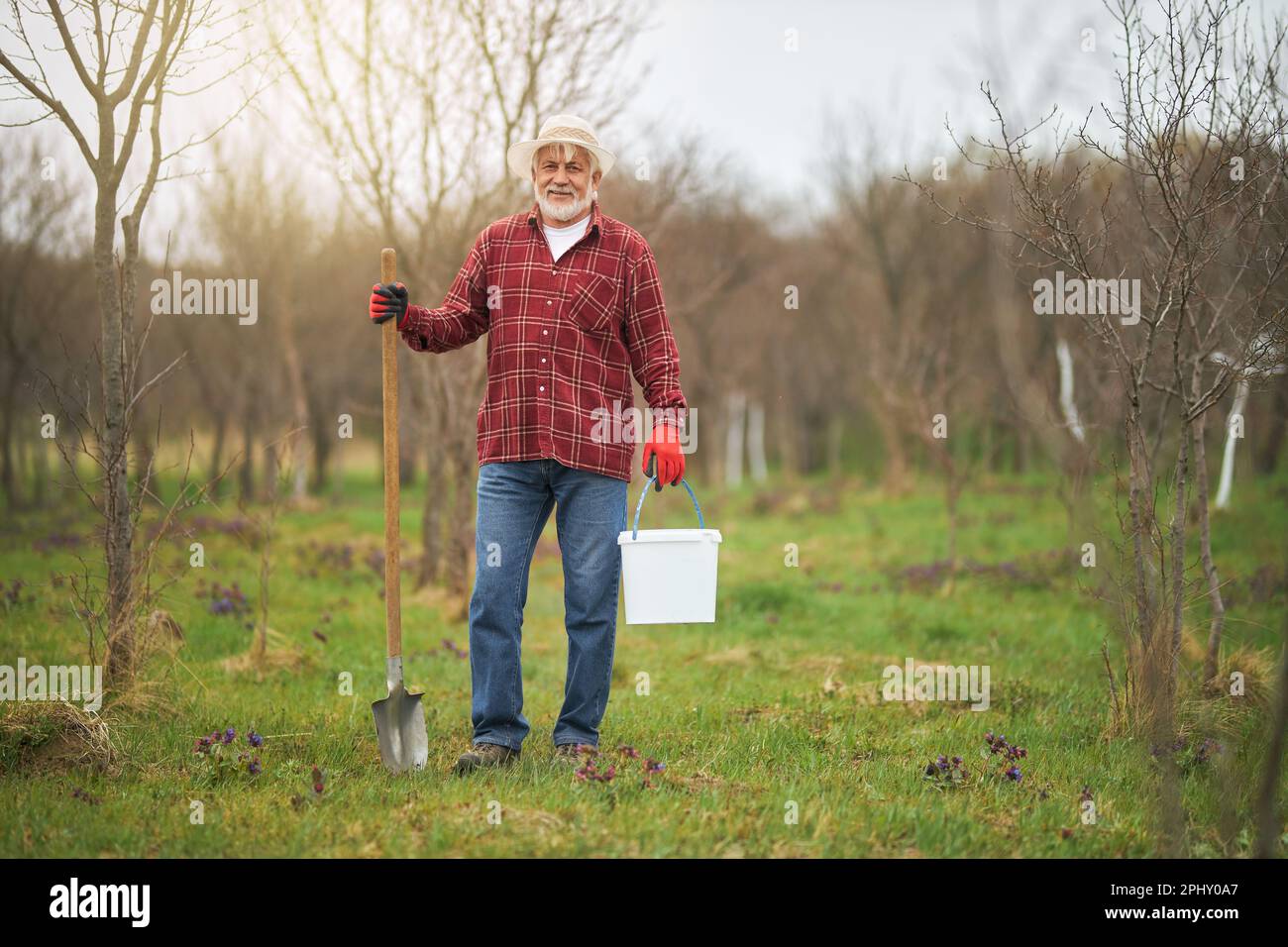 Peasant working in orchard in spring Stock Photo - Alamy