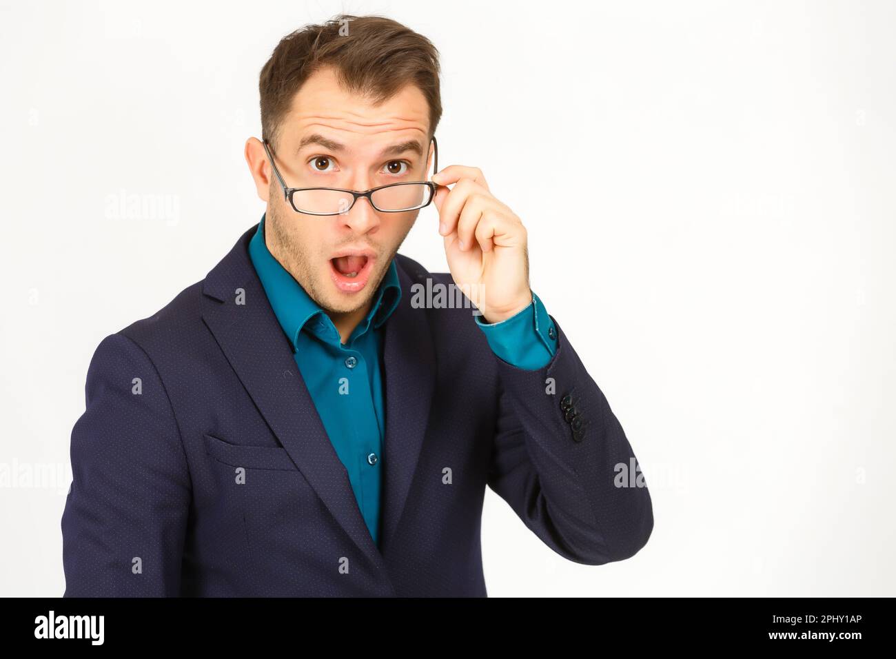 A view of a shocked young businessman isolated on white background ...