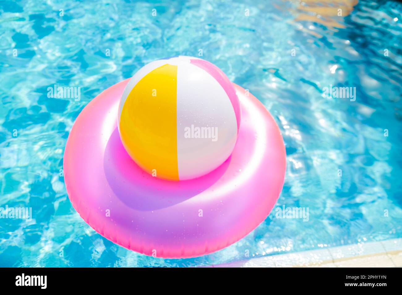 Inflatable pool ball on lifebuoy in the pool Stock Photo - Alamy