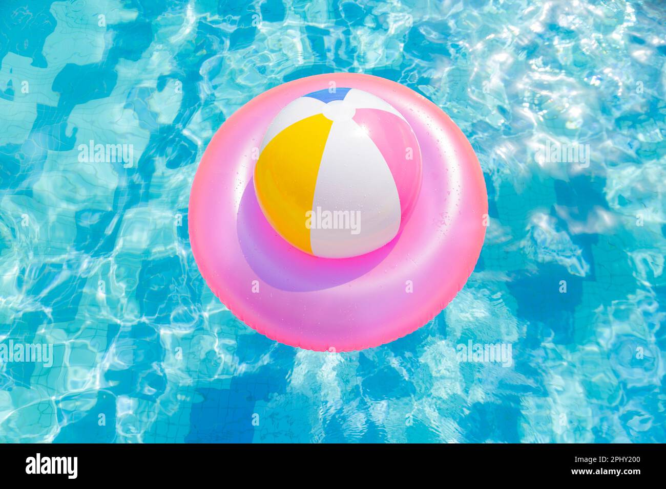 Inflatable pool ball on lifebuoy in the pool Stock Photo - Alamy