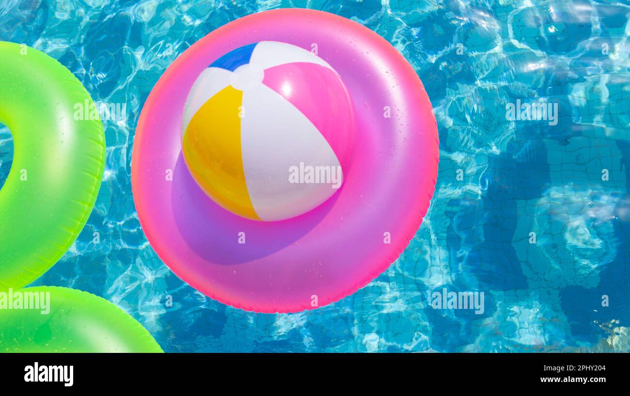 Inflatable pool ball on lifebuoy in the pool Stock Photo - Alamy