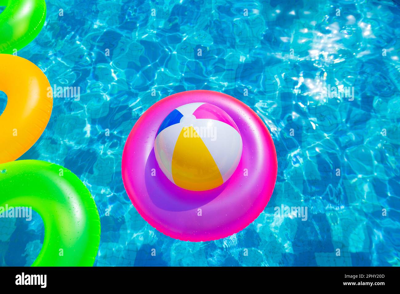 Inflatable pool ball on lifebuoy in the pool Stock Photo - Alamy