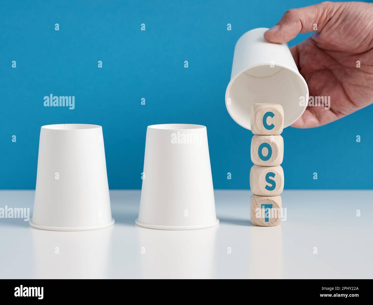 Finding the hidden costs concept. Man playing the shell game with three ...