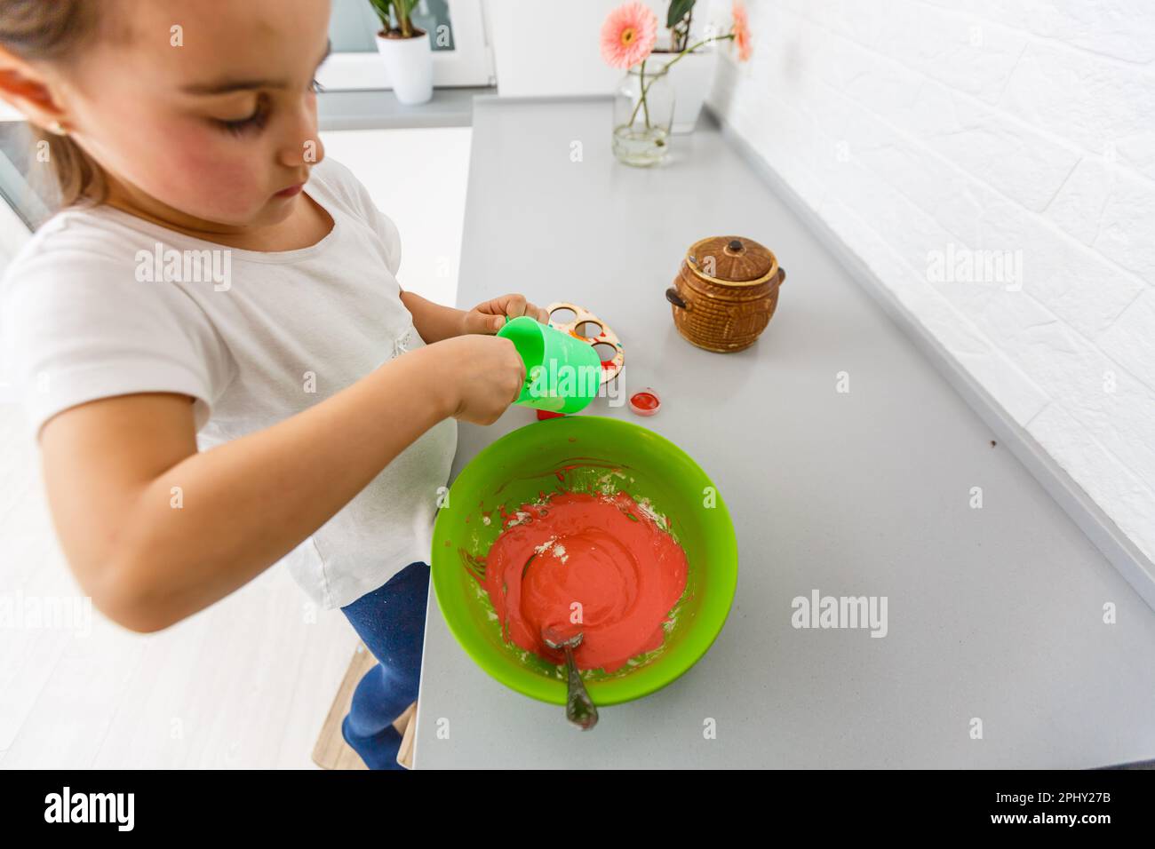 Little girl kneads colored dough to make homemade plasticine Stock ...