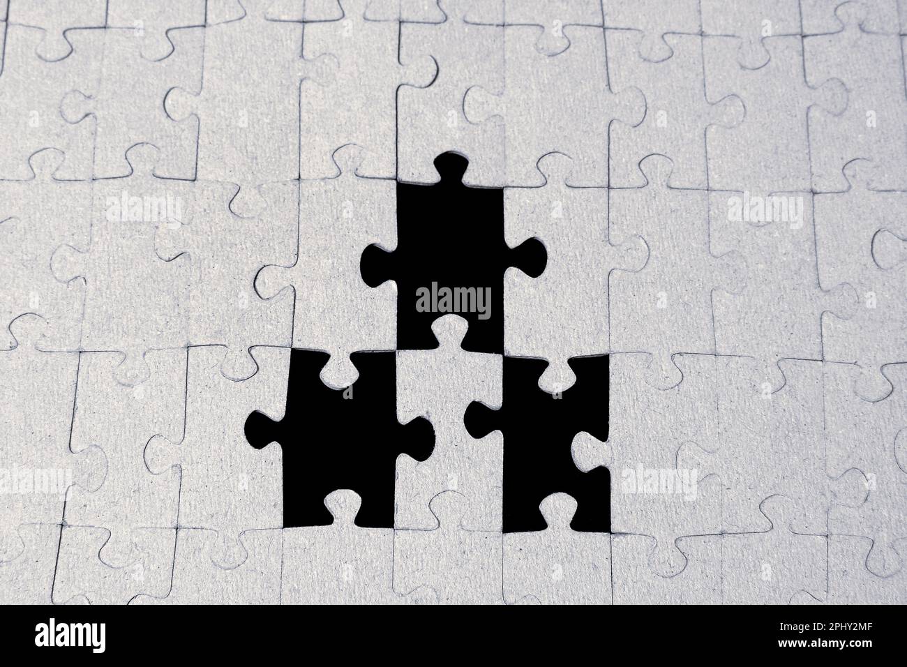 three puzzle pieces are missing in a nearly finished puzzle Stock Photo ...