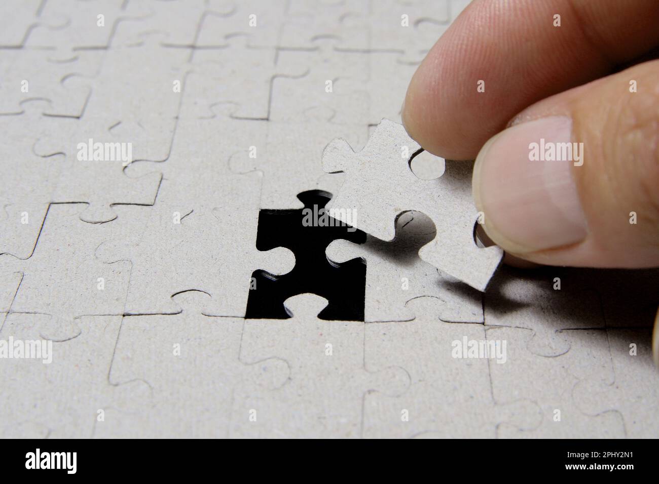 putting in the last piece of the puzzle Stock Photo - Alamy