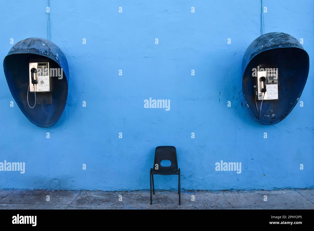 typical public phones in cuba with a seat, which can be used for long ...