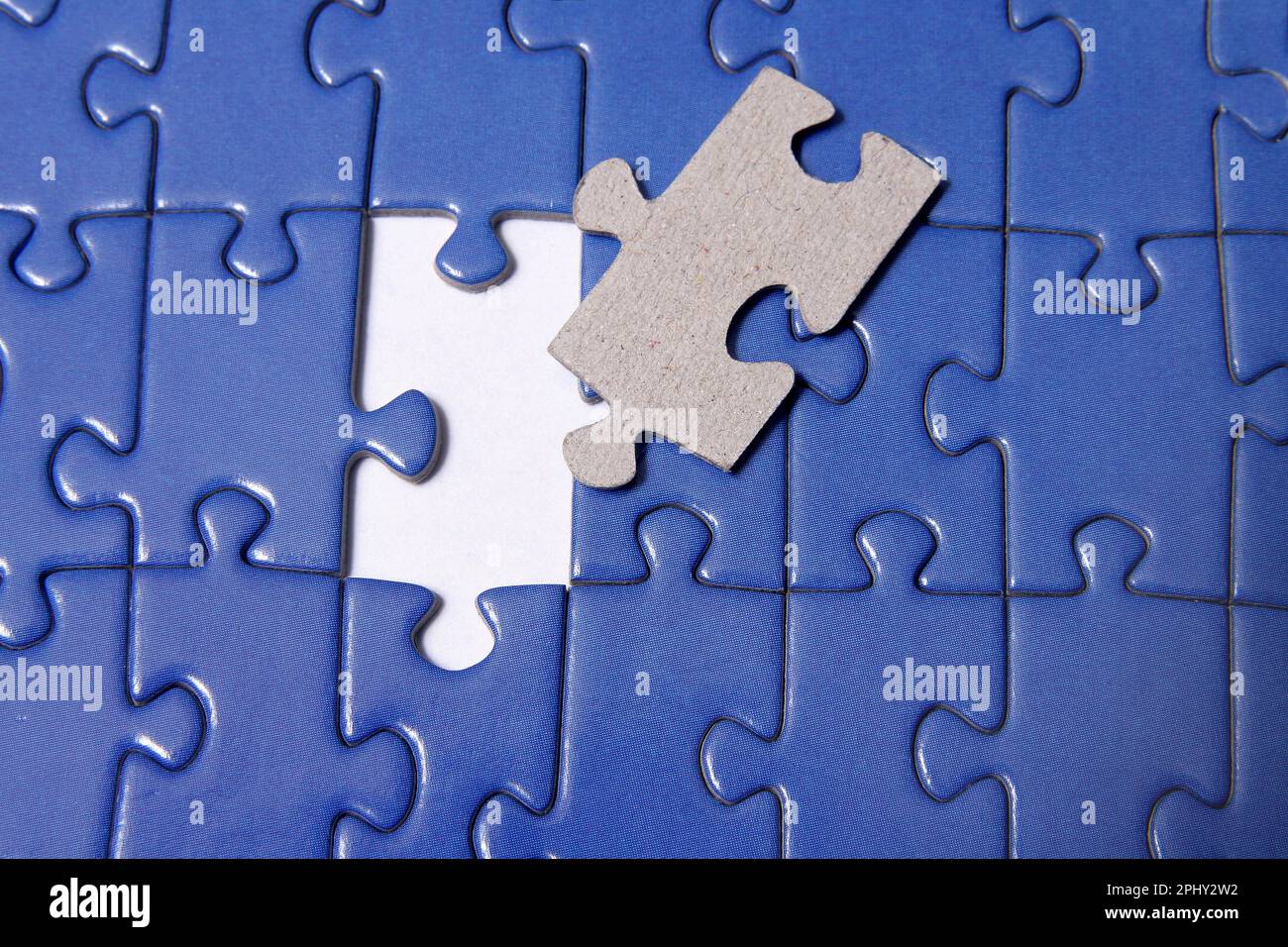 last piece of a puzzle on a nearly finished puzzle Stock Photo - Alamy