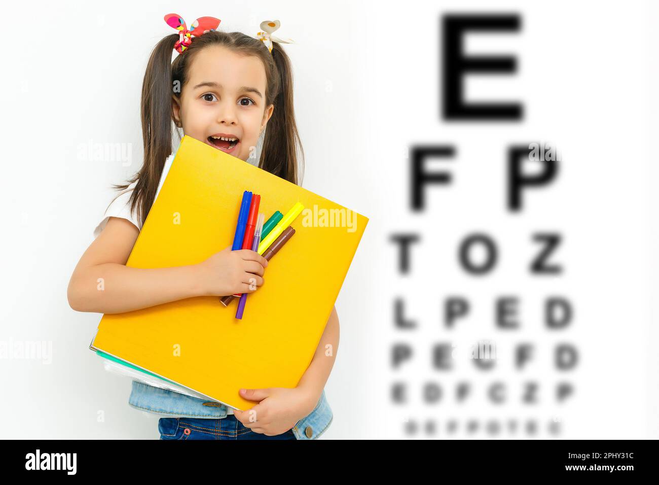 Child at eye sight test. Little kid selecting glasses at optician store ...
