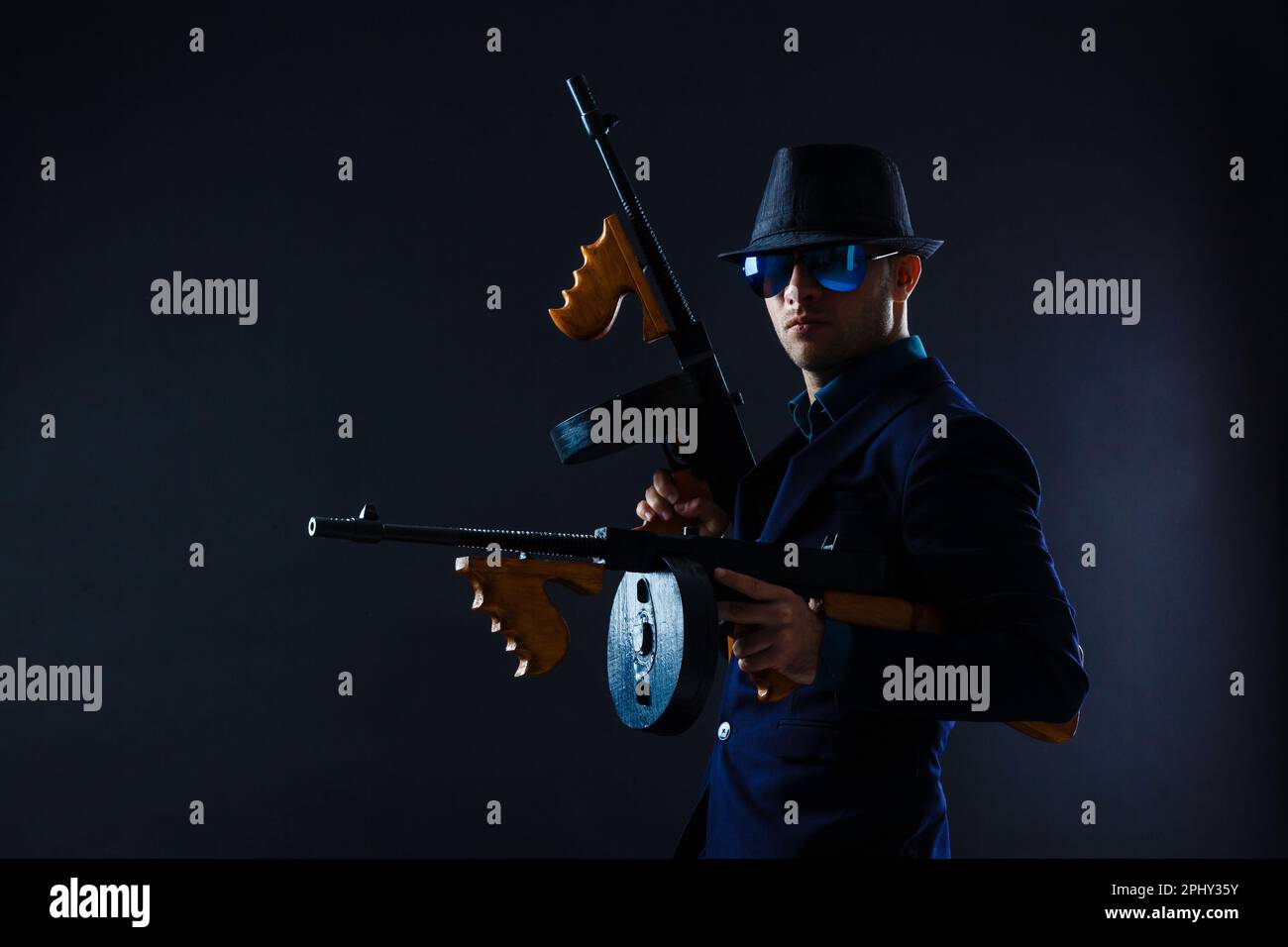 low key portrait of young gangster with hat in the darkness Stock Photo ...