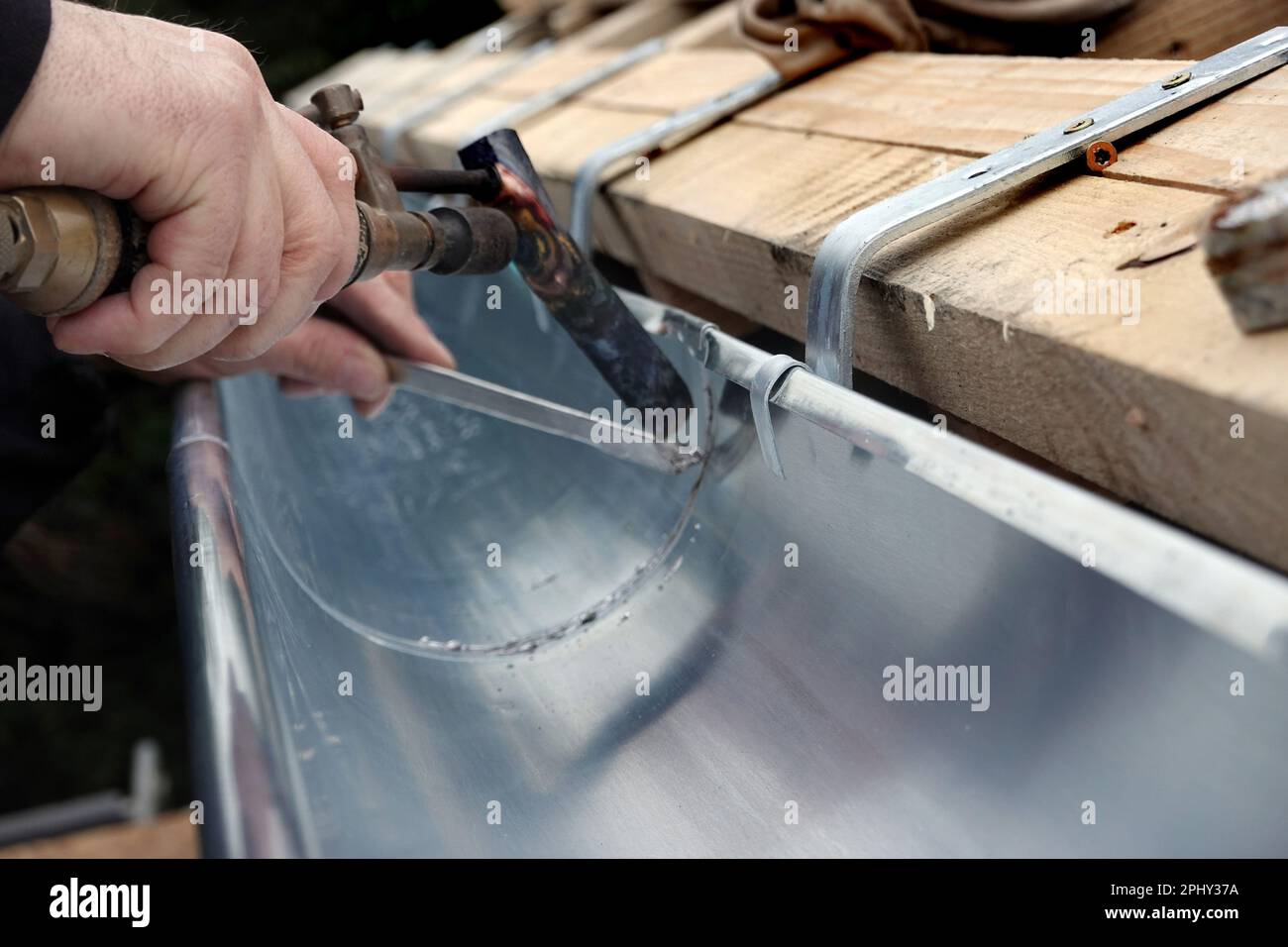 roofer soldering the seam of a gutter, Germany Stock Photo - Alamy