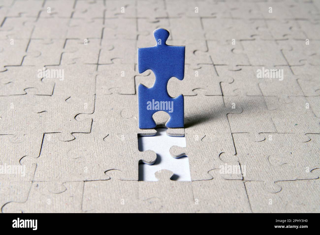 last piece of a puzzle on a nearly finished puzzle Stock Photo - Alamy