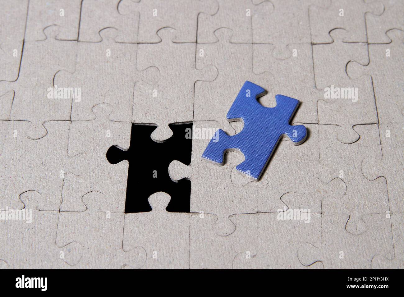 last piece of a puzzle on a nearly finished puzzle Stock Photo - Alamy