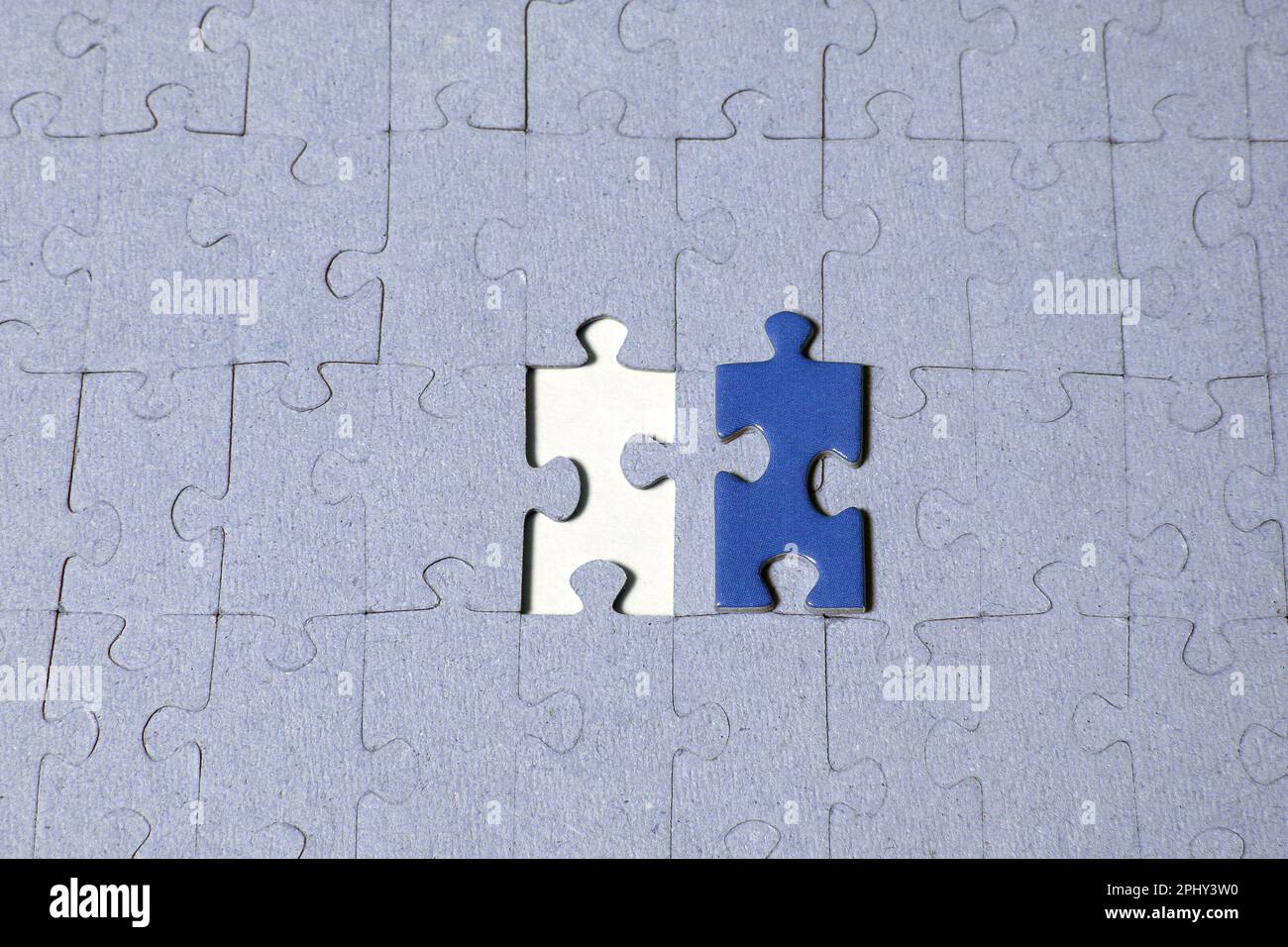 last piece of a puzzle on a nearly finished puzzle Stock Photo - Alamy