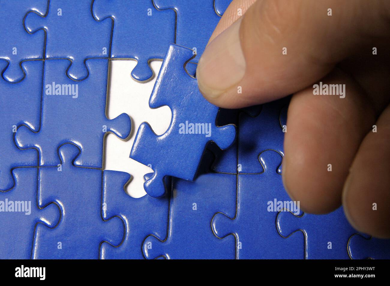 putting in the last piece of the puzzle Stock Photo - Alamy