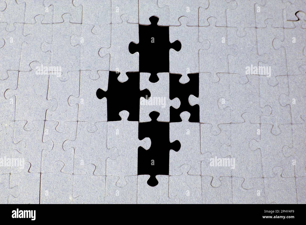 four puzzle pieces are missing in a nearly finished puzzle Stock Photo ...