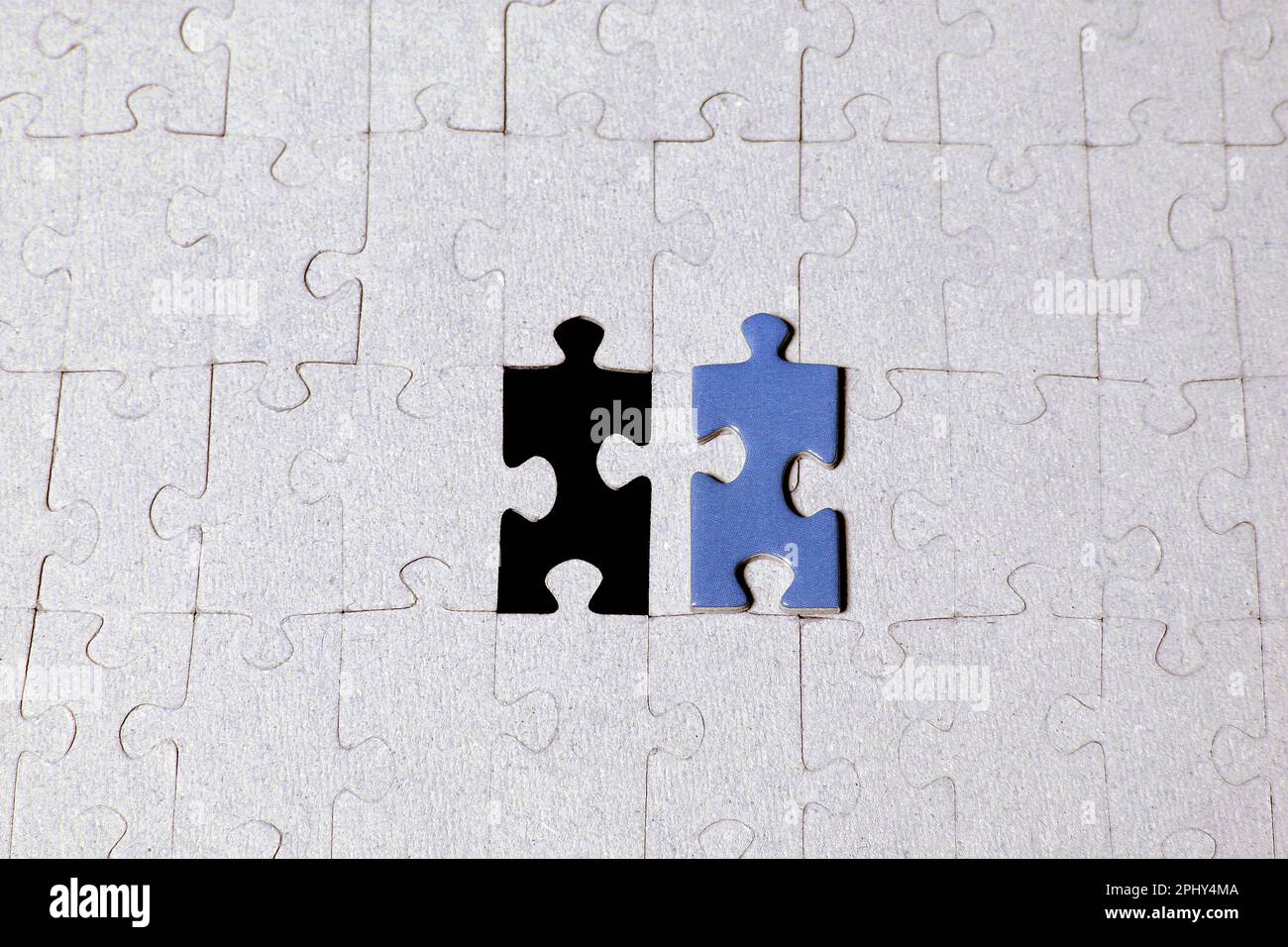 last piece of a puzzle on a nearly finished puzzle Stock Photo - Alamy
