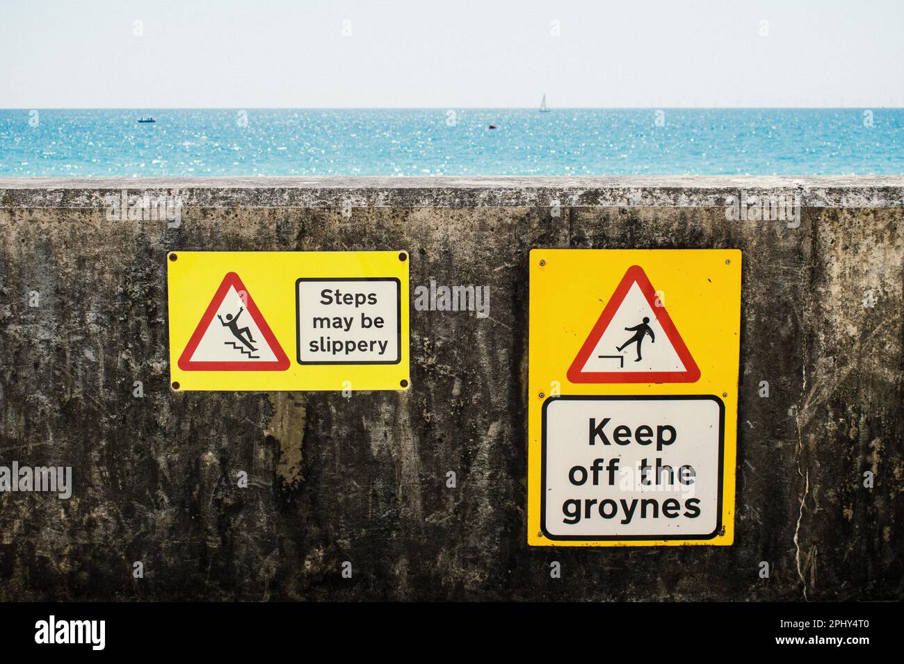 Sea wall with warning signs hi-res stock photography and images - Alamy