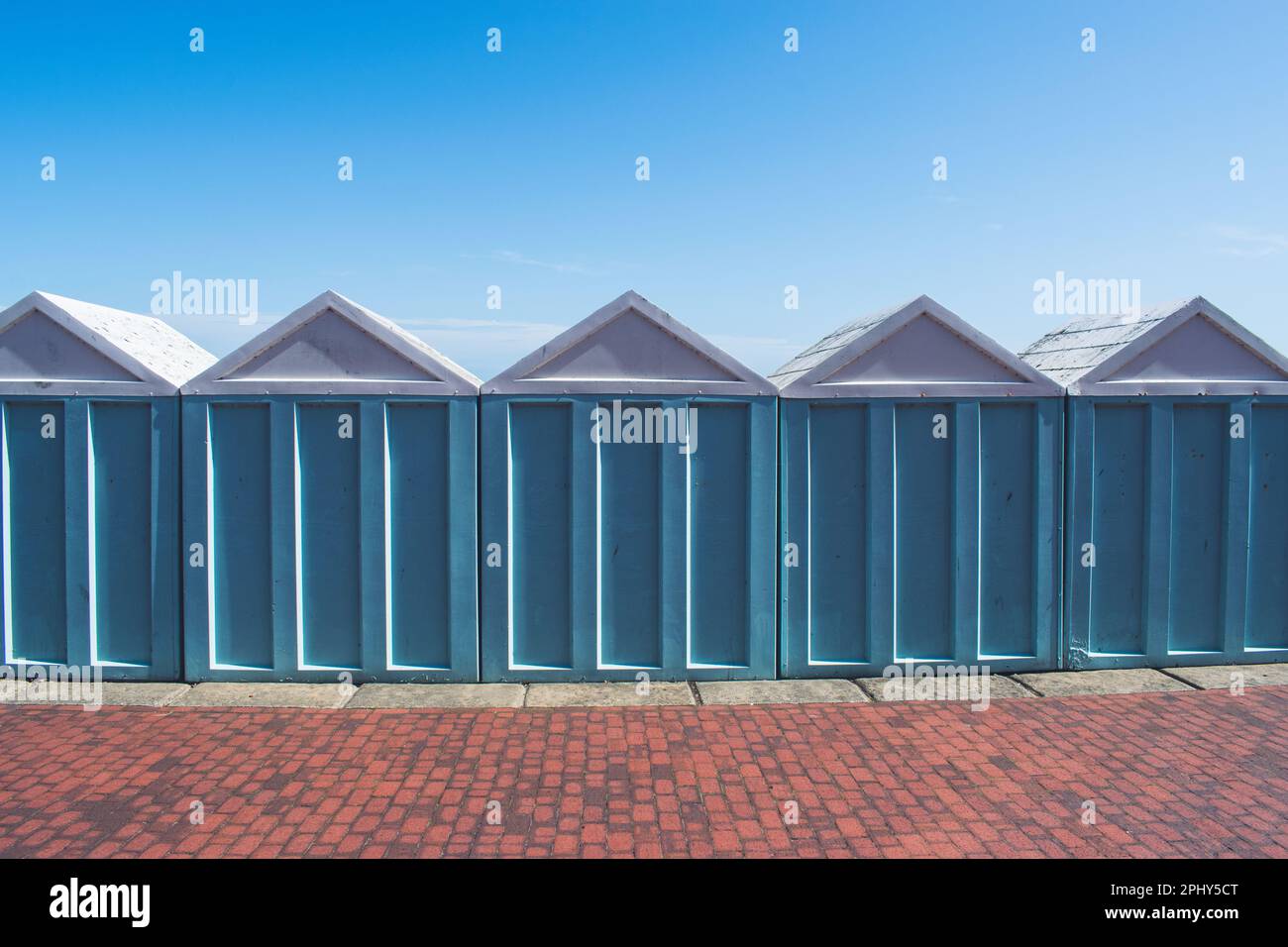 Mid shot of blue beach huts on the sea front Stock Photo - Alamy