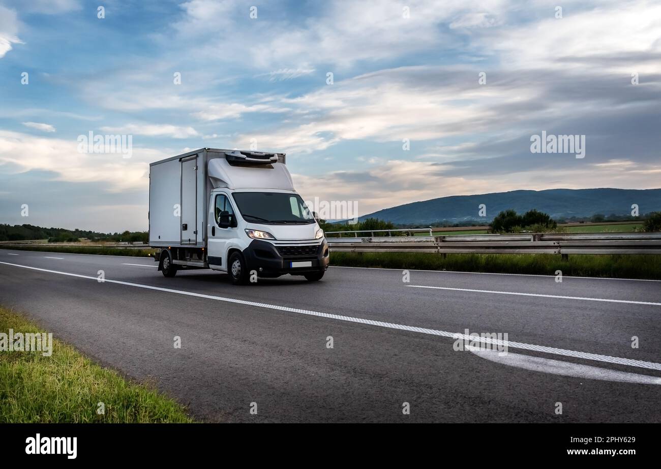 White cargo van at the interurban road Stock Photo - Alamy