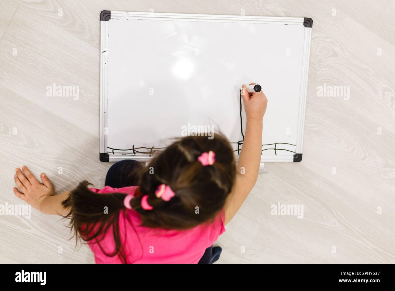 Image of happy little girl sitting near a lot of colouring pencils over ...