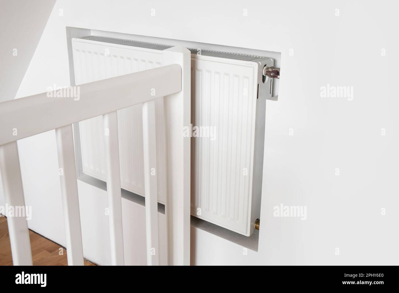 White hot water heater radiator built inside drywall indoors at home ...