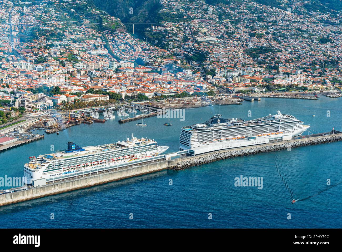 An aerial view of Funchals bustling port and harbor, with a variety of ...