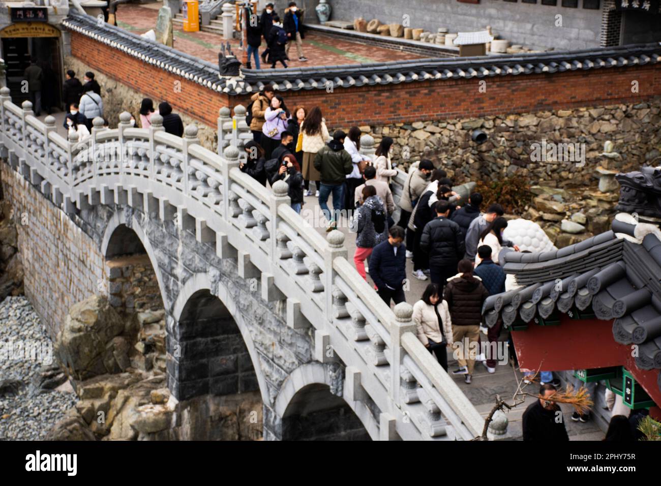 Korean people travelers walking crossing antique stone bridge travel ...
