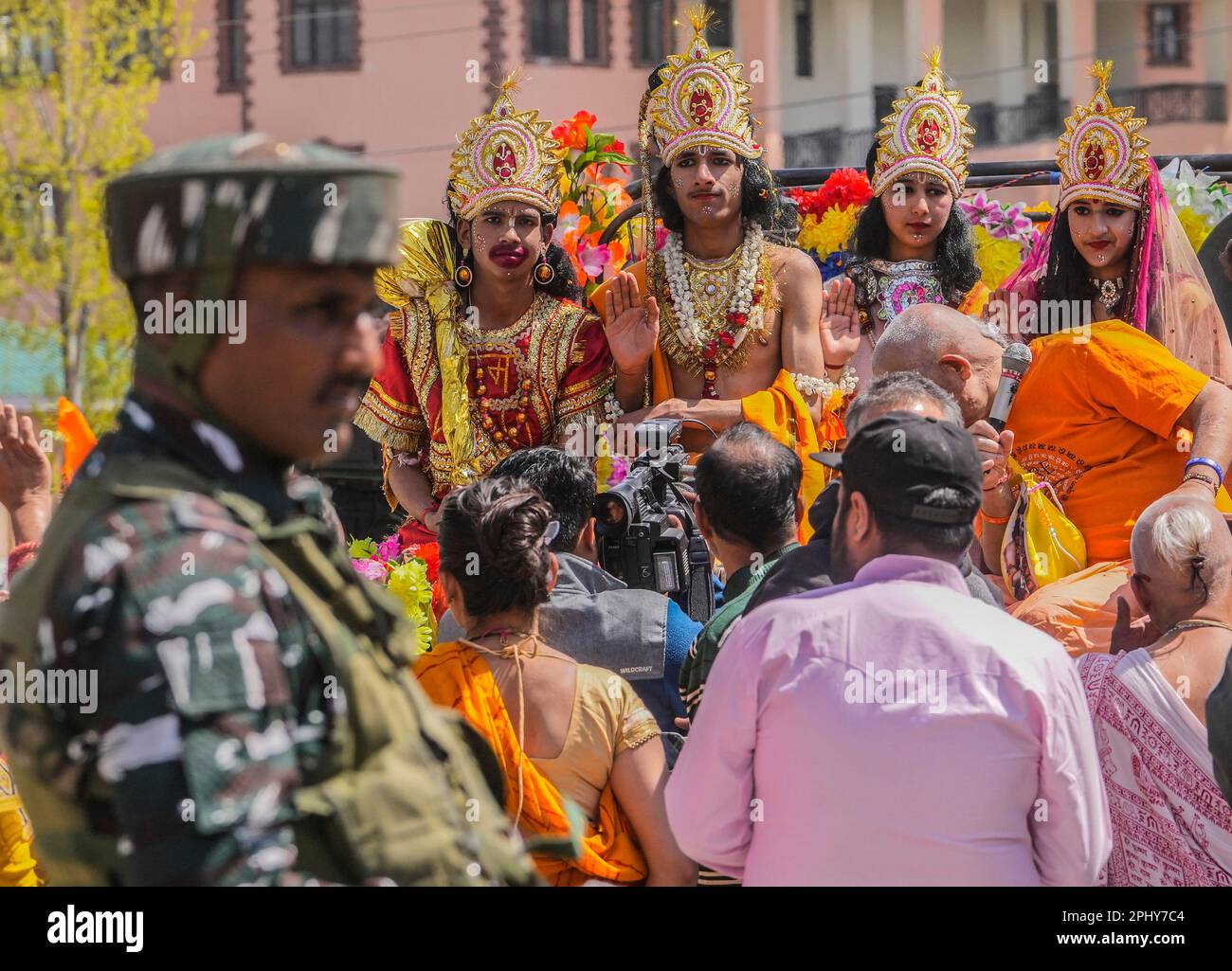 An Indian paramilitary soldier stands guard as Kashmiri Hindus take ...