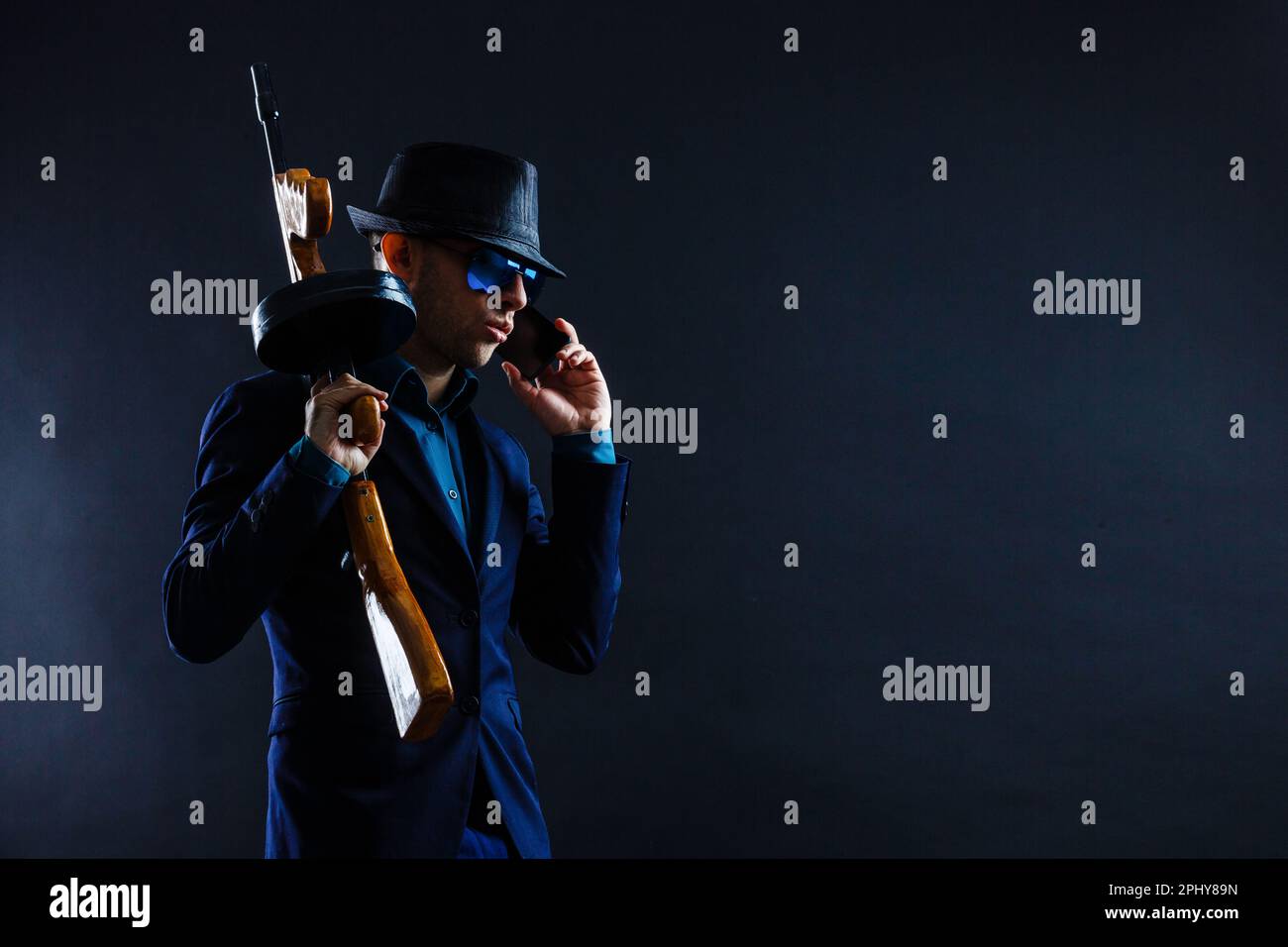 low key portrait of young gangster with hat in the darkness Stock Photo ...