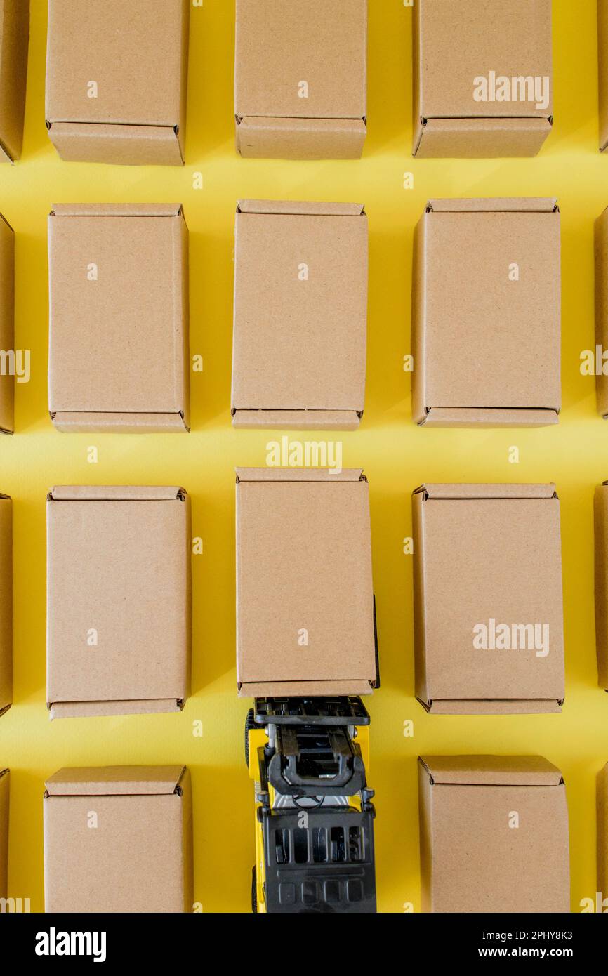 Warehouse with cardboard kraft boxes and a forklift truck. Cargo ...
