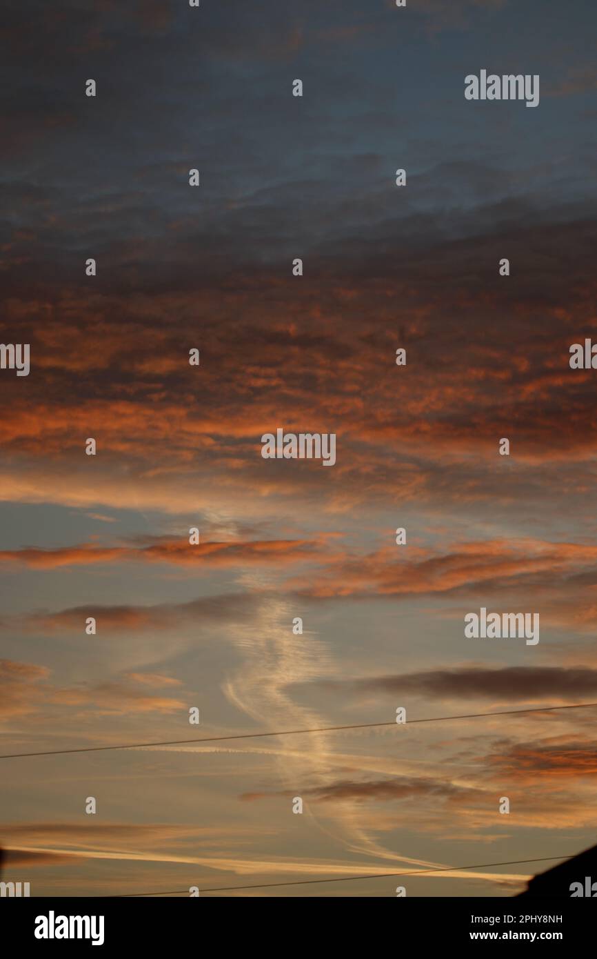 A breathtaking image of a vibrant red and yellow sunset with airplane ...