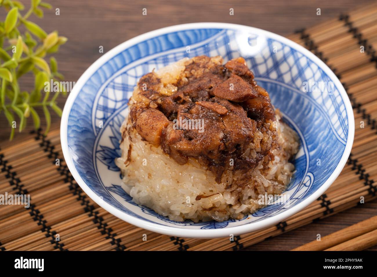 Migao, tube rice cake, rice pudding in a bowl topped with minced pork ...