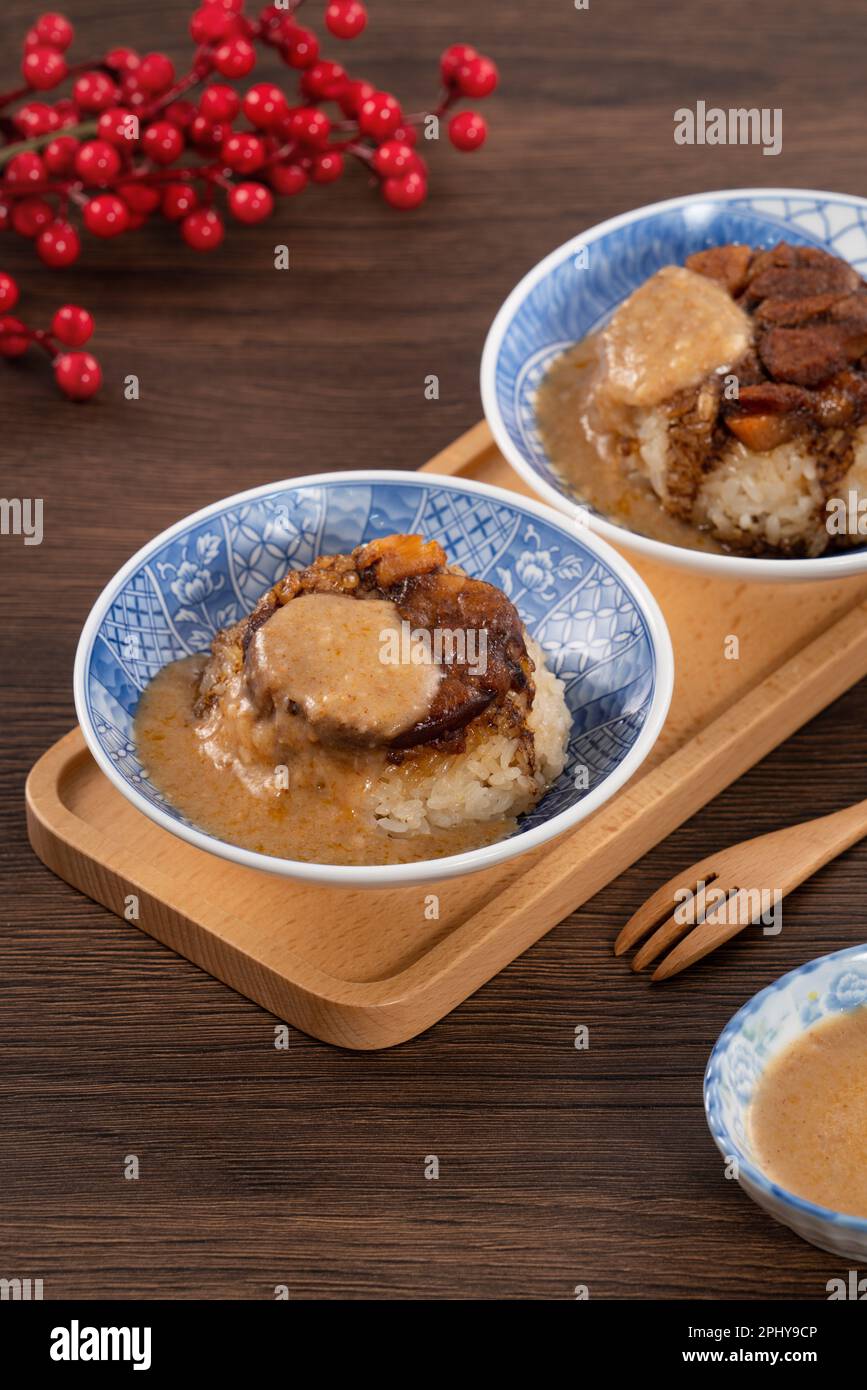 Migao, tube rice cake, rice pudding in a bowl topped with minced pork ...