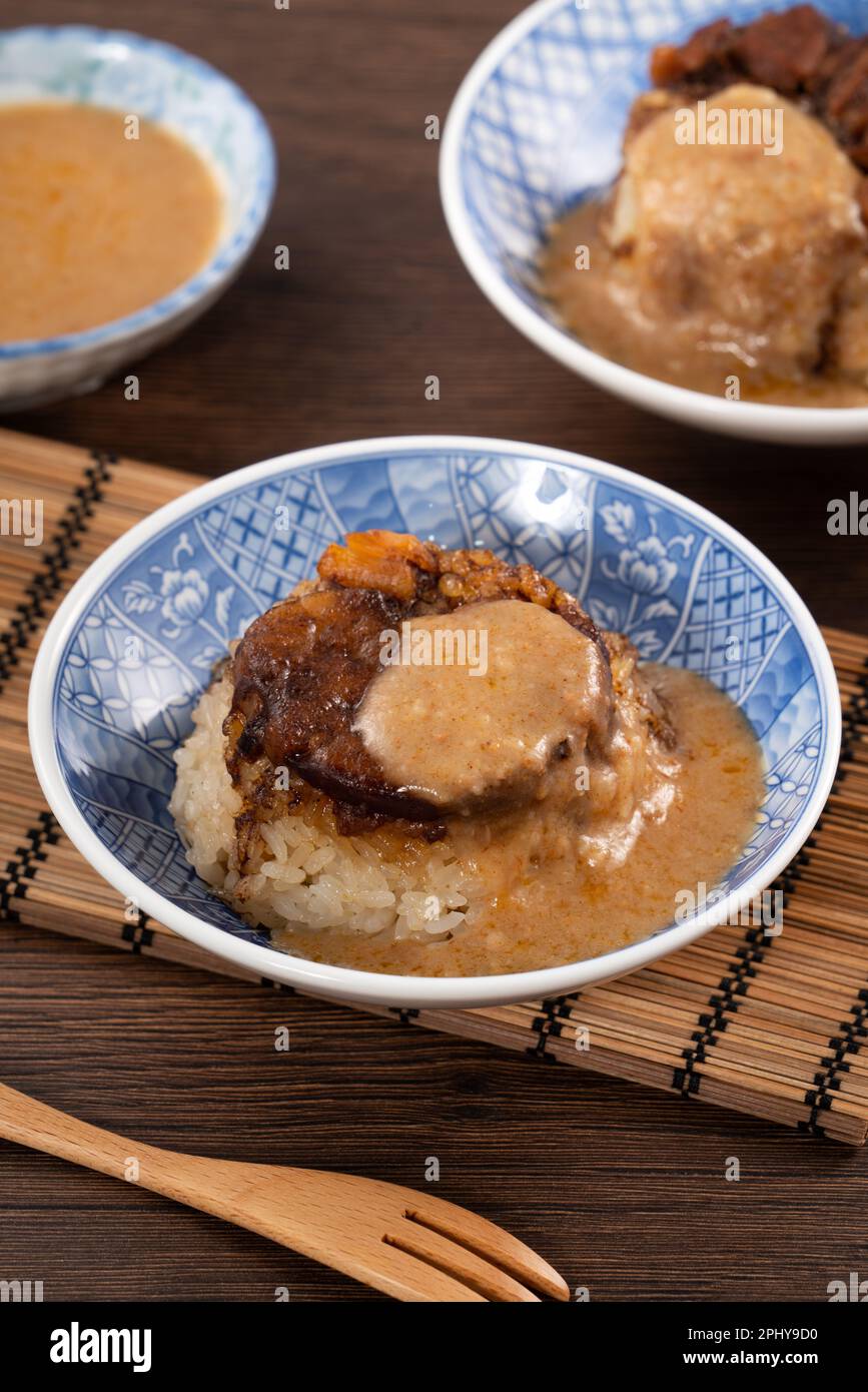 Migao, tube rice cake, rice pudding in a bowl topped with minced pork ...