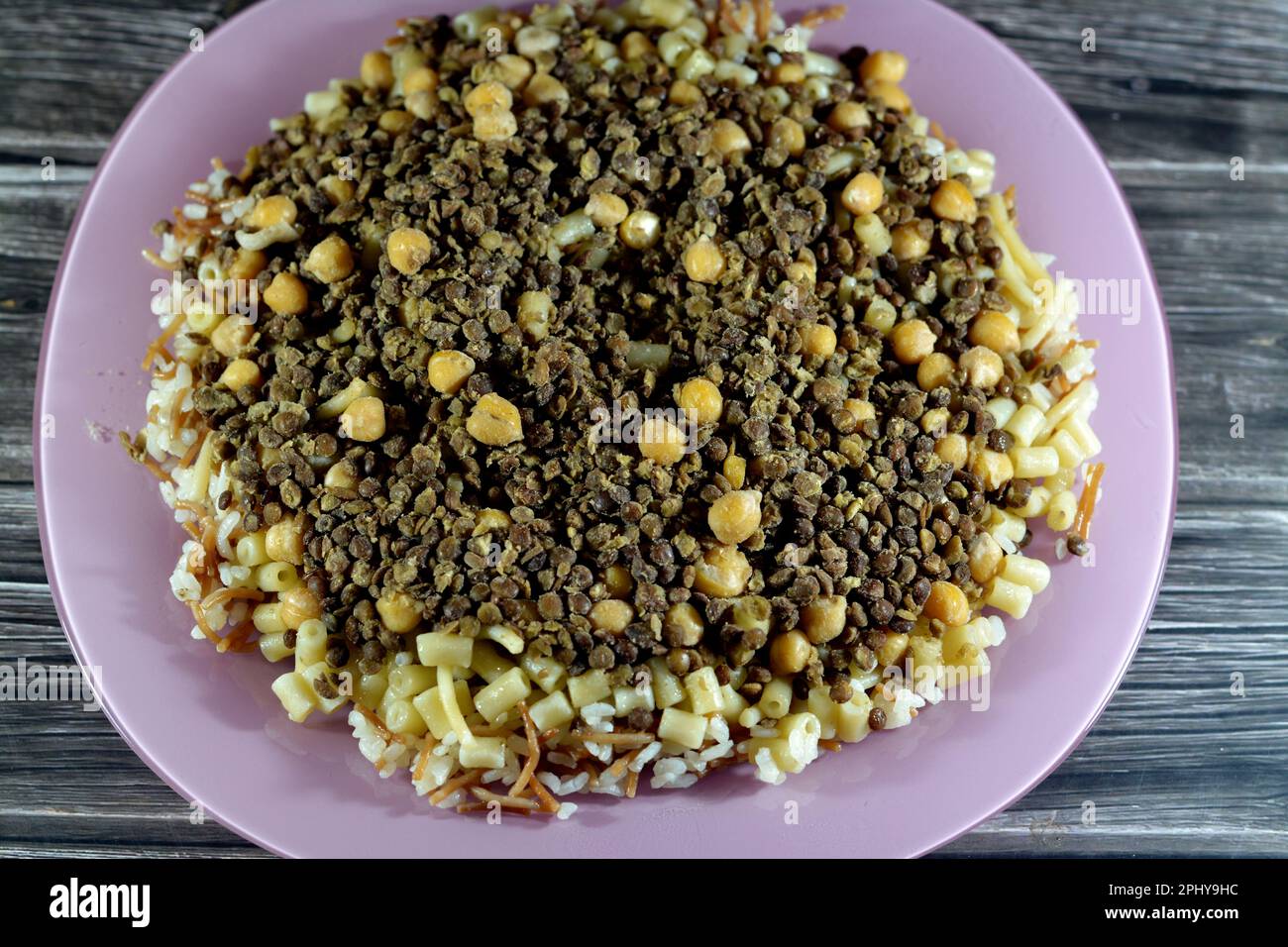 Egyptian cuisine of Koshary, a popular street food made of rice ...