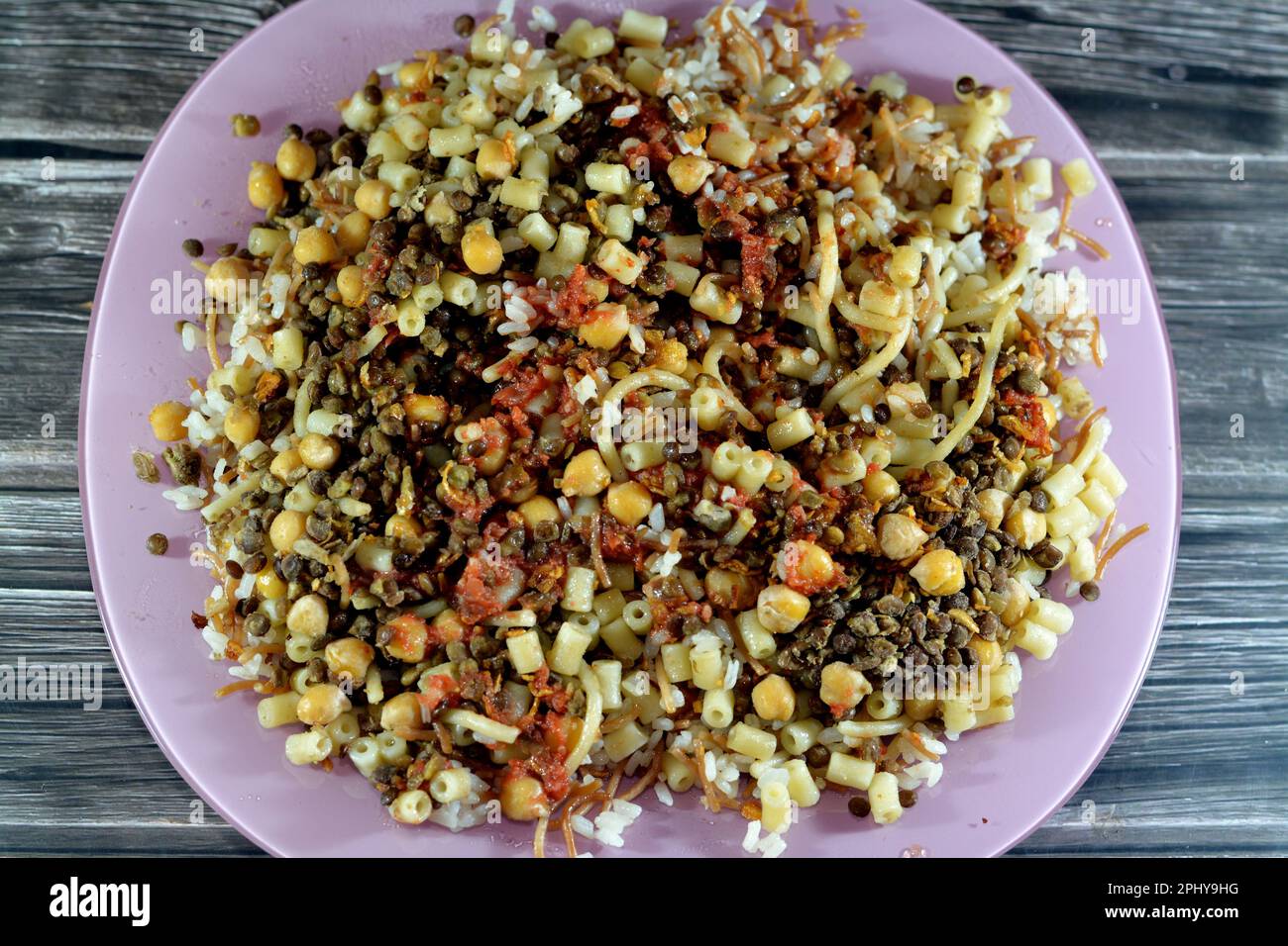 Egyptian cuisine of Koshary, a popular street food made of rice ...