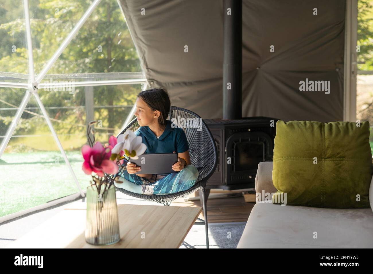 childhood, technology and hygge concept - happy little girl with tablet ...