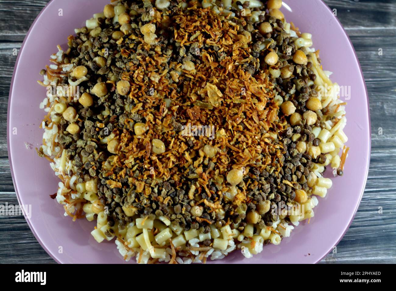 Egyptian cuisine of Koshary, a popular street food made of rice ...