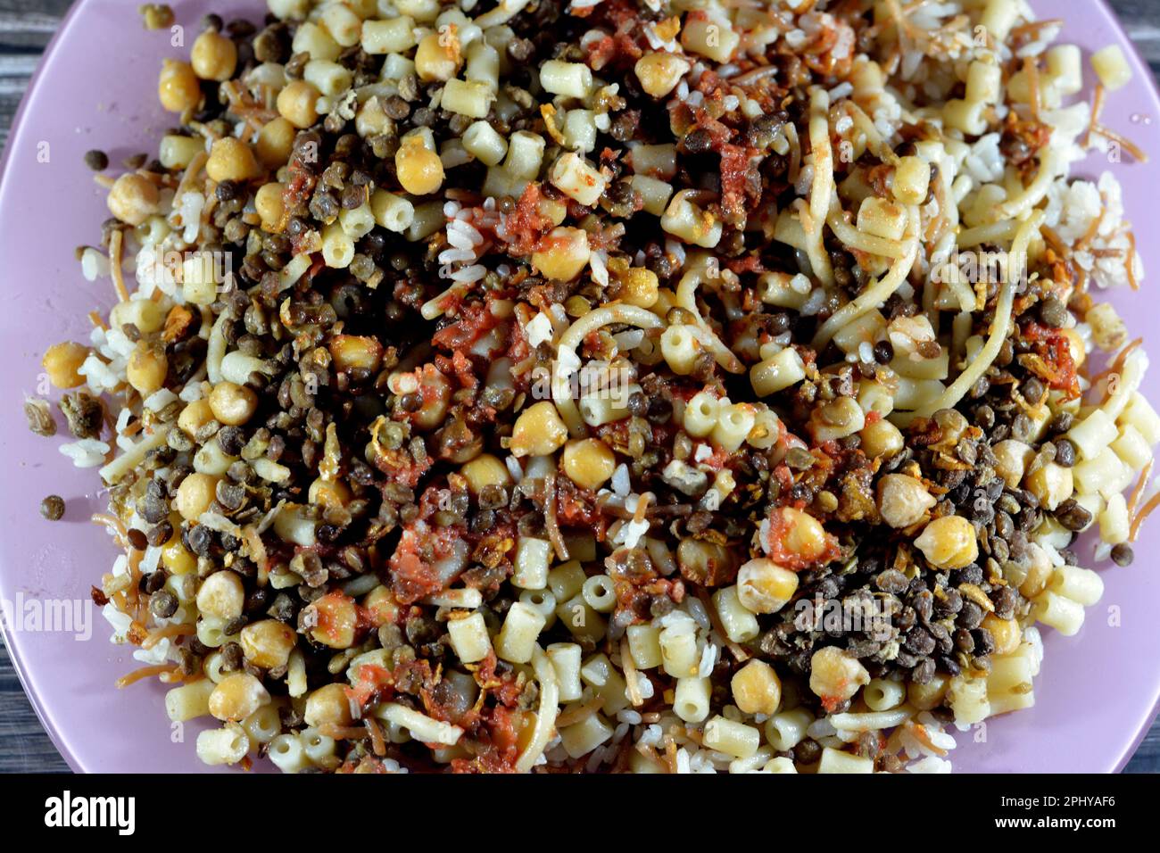 Egyptian cuisine of Koshary, a popular street food made of rice ...