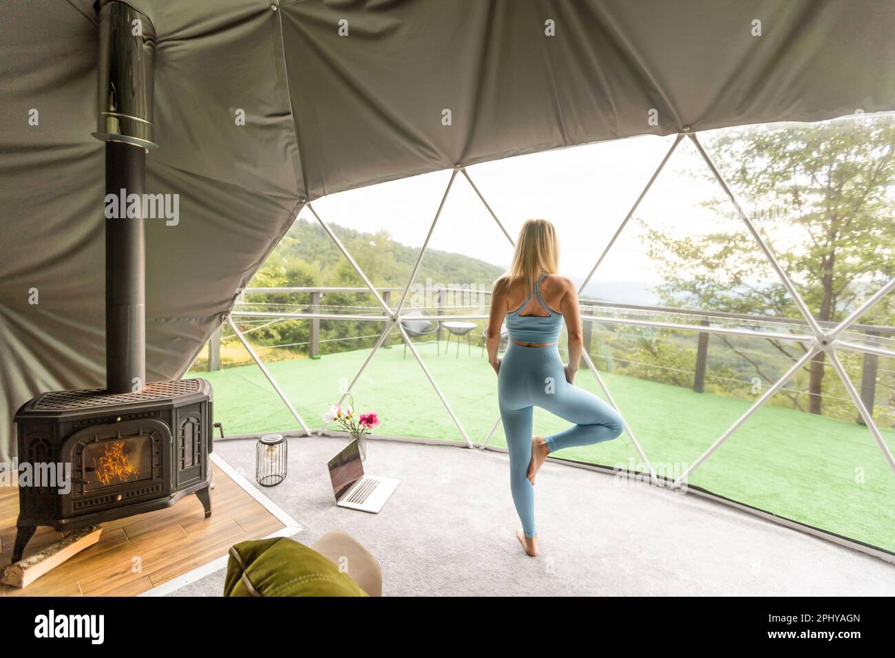 woman doing yoga in glamping dome tent Stock Photo - Alamy