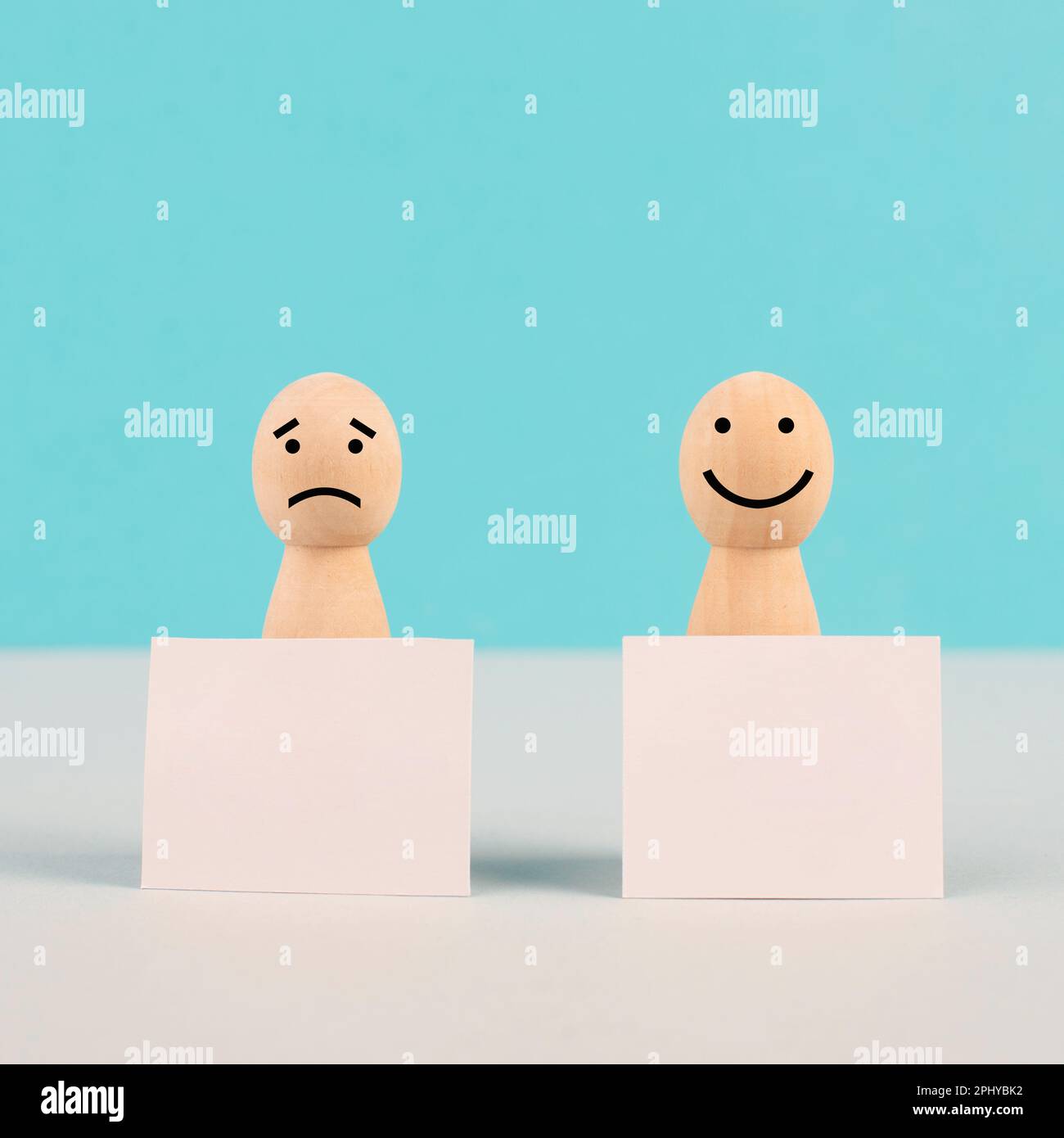 Man with a sad and a happy face holding empty signs, positive and ...