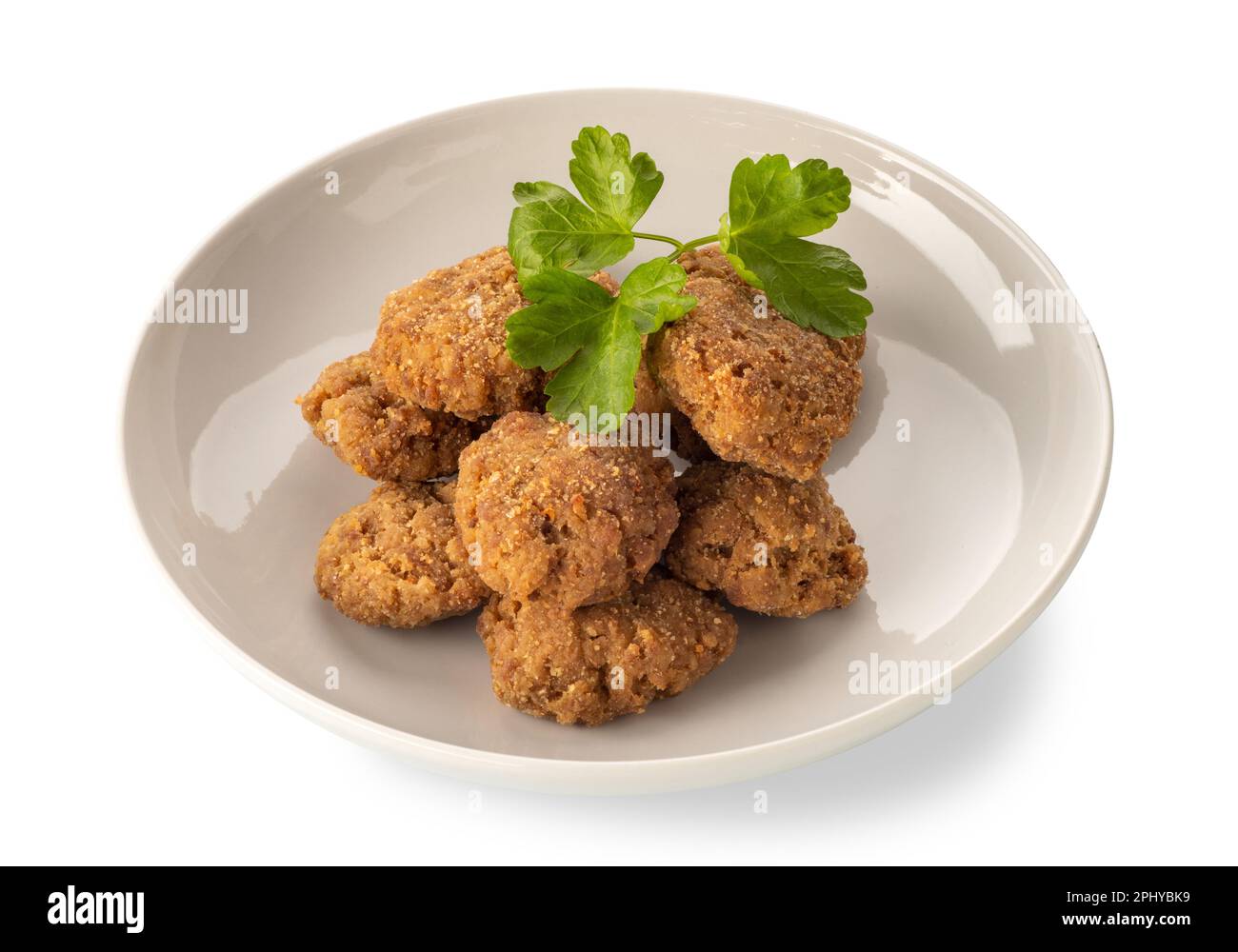Breaded meatballs fried in white dish with parsley leaves, isolated on ...