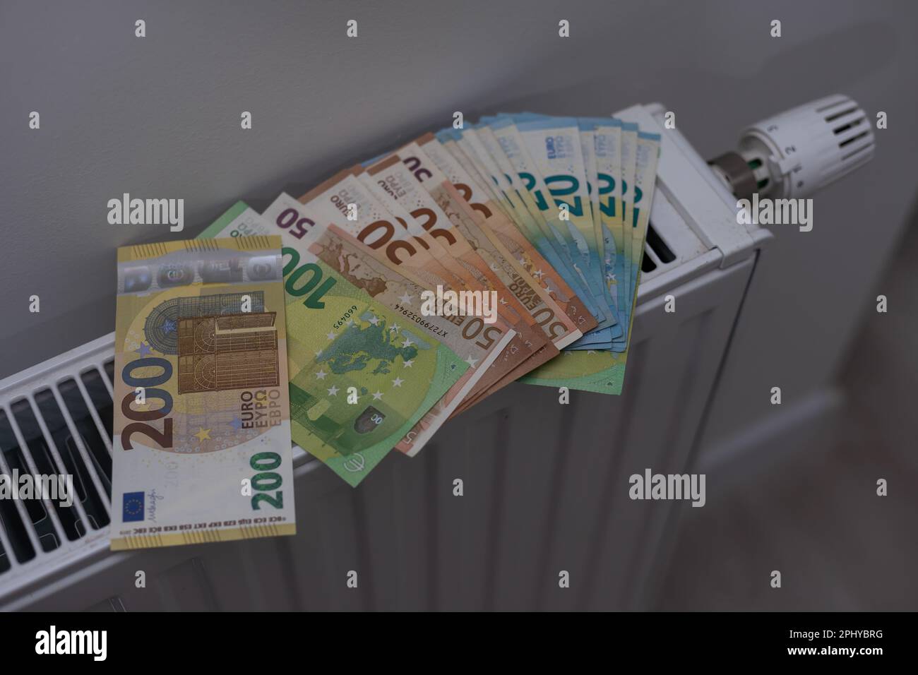 Money on heating battery. euros Stock Photo - Alamy