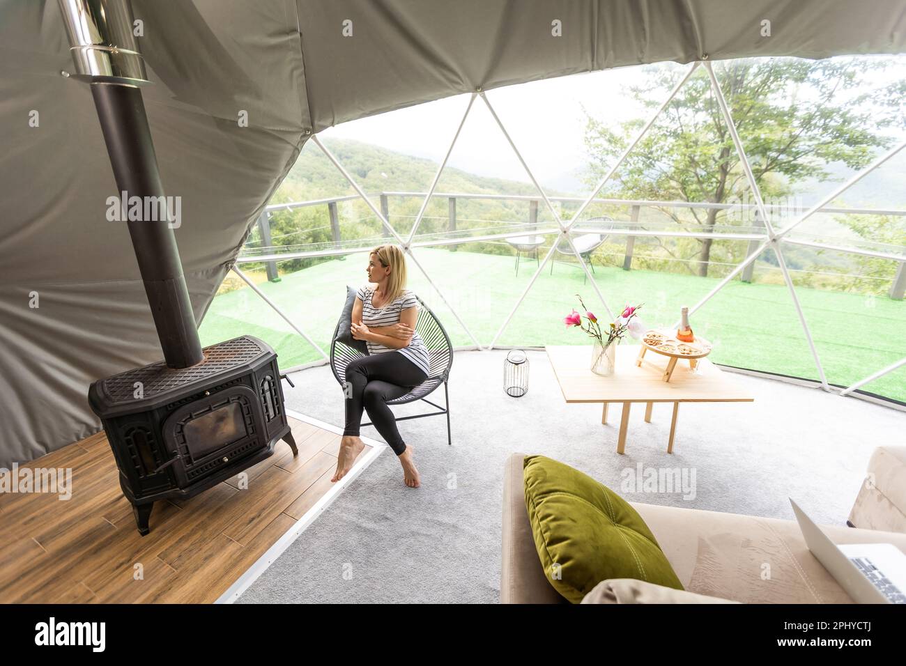 a woman enjoys solitude inside of a transparent bubble hotel Stock ...